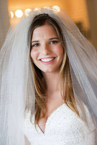 Caucasian bride smiling in wedding gown and veil - Royalty-free Stock ...