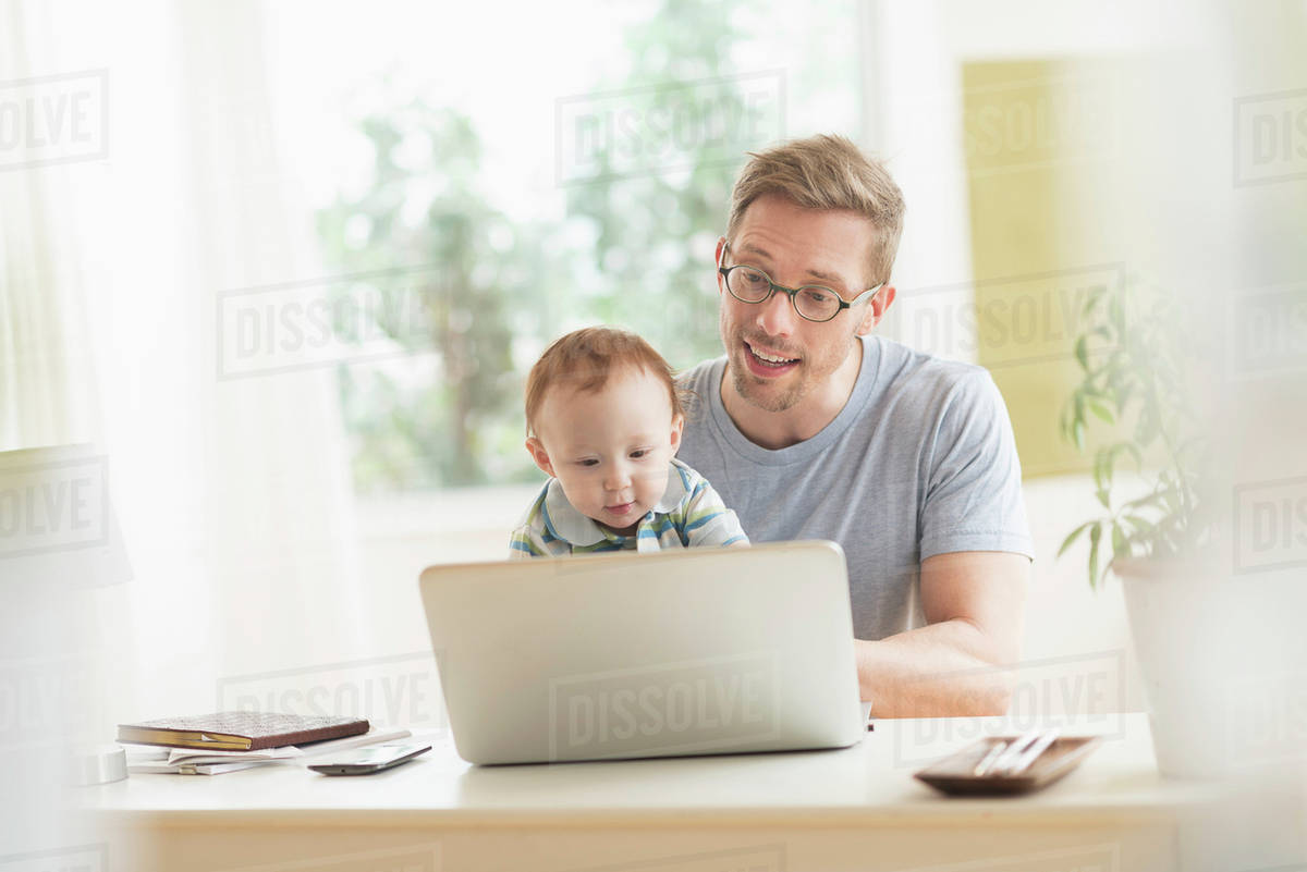 Caucasian father and baby using laptop - Royalty-free Stock Photo ...