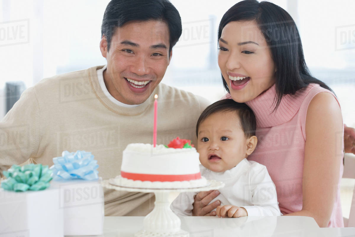 Asian family celebrating baby's first birthday - Stock Photo - Dissolve