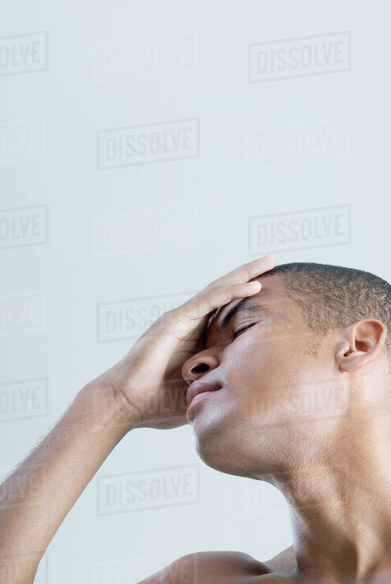 African man with hand on head - Royalty-free Stock Photo | Dissolve