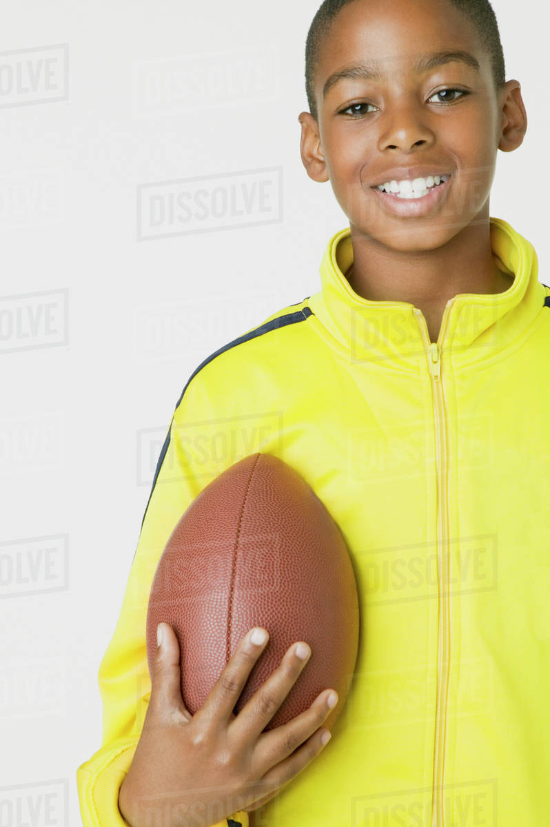 African boy holding football - Stock Photo - Dissolve