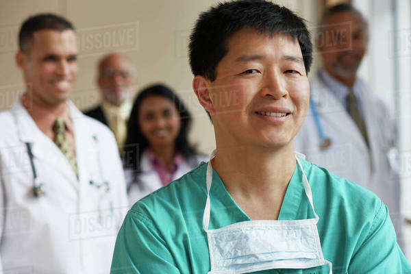 Male Asian surgeon with co-workers in the background - Royalty-free ...