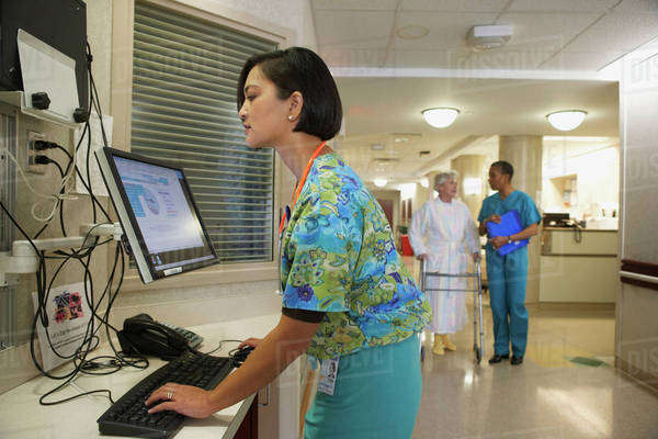 Female nurse using computer - Stock Photo - Dissolve