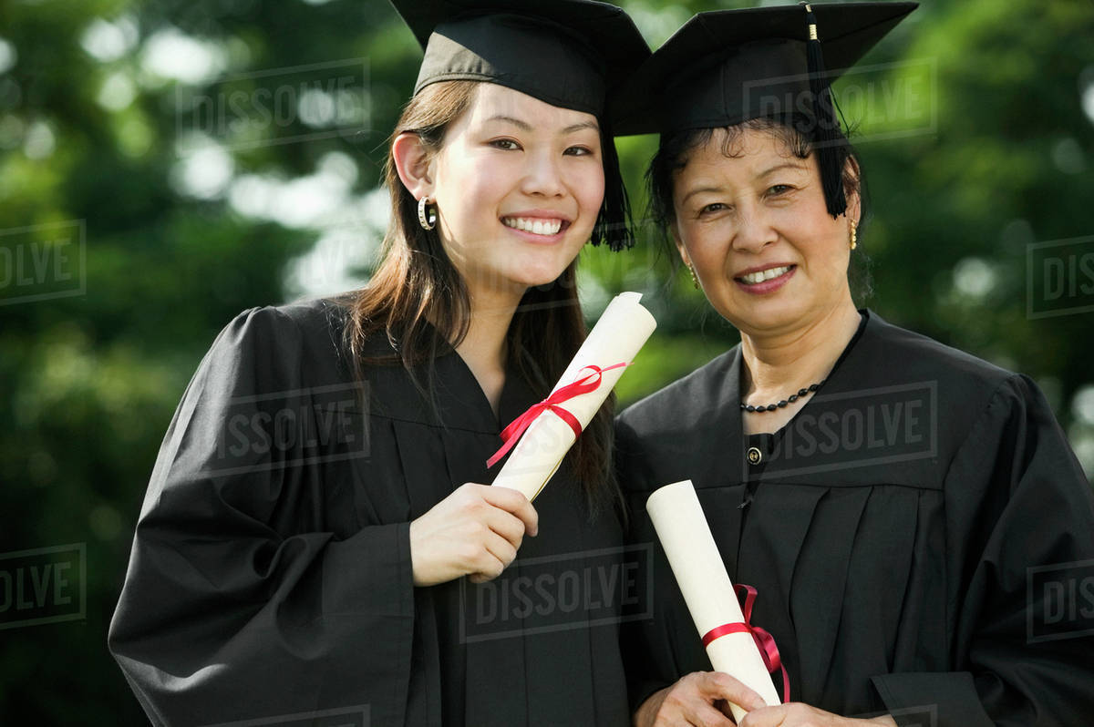 Young and mature women graduating together - Stock Photo - Dissolve
