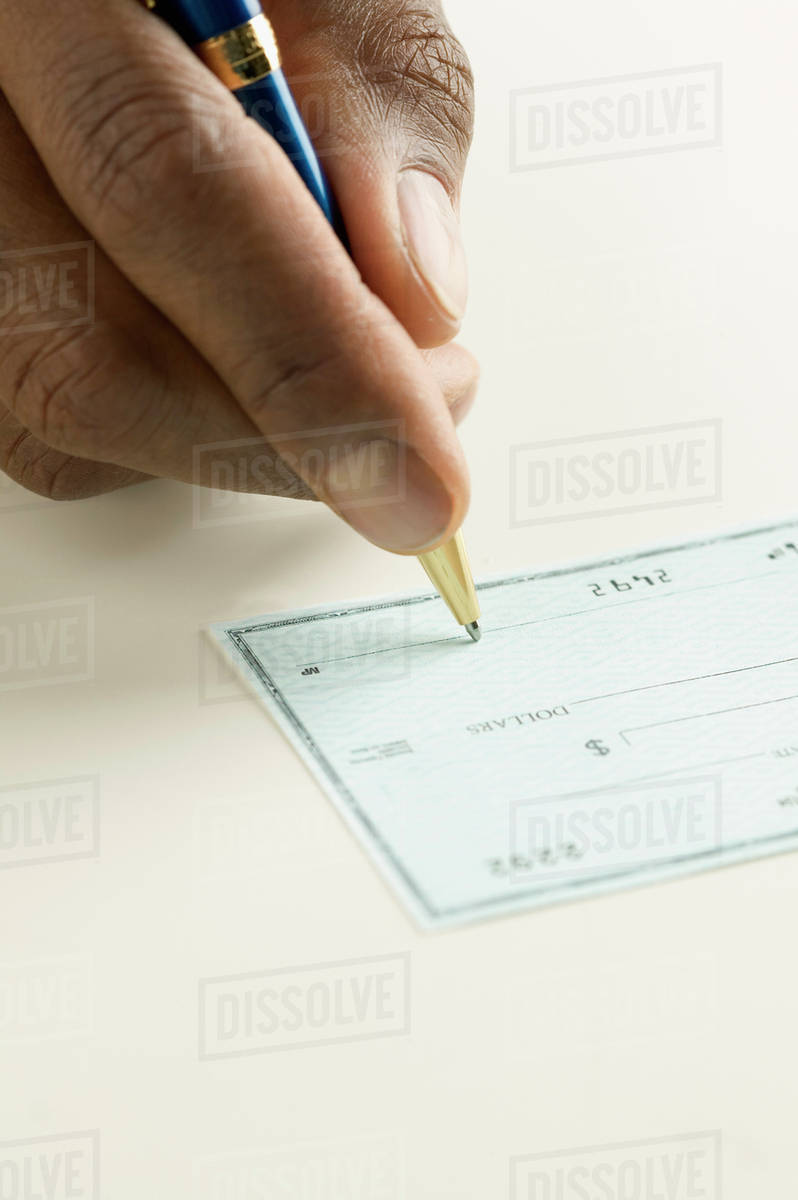 Close up of hand writing check - Royalty-free Stock Photo | Dissolve
