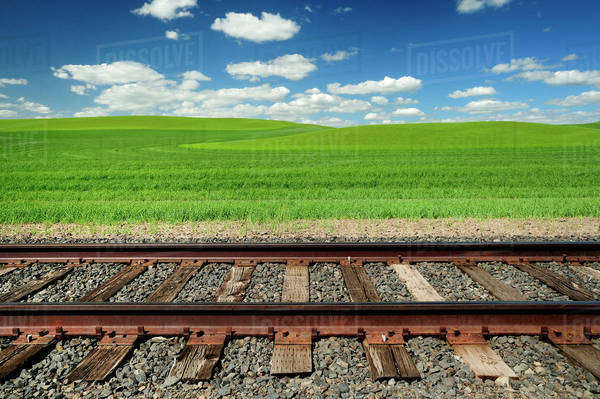 Railroad tracks and rolling hills in rural landscape - Royalty-free ...