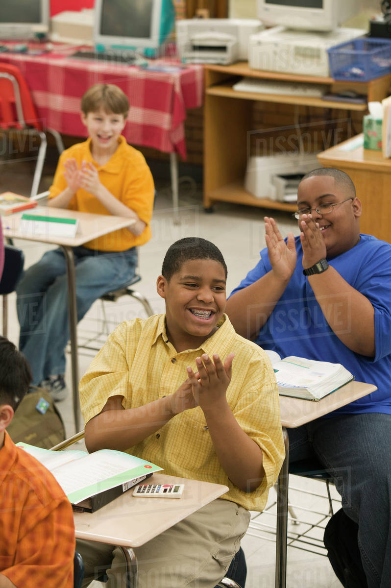 Students clapping in classroom - Royalty-free Stock Photo | Dissolve