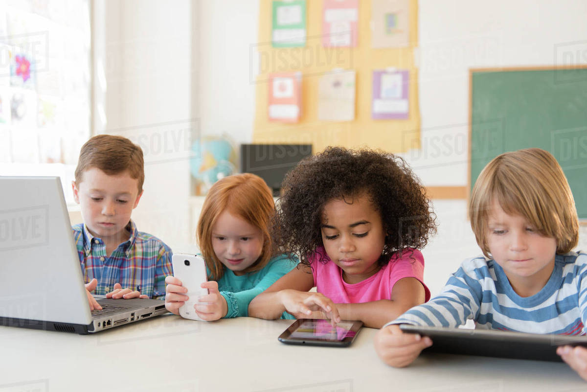 Students using technology in classroom - Stock Photo - Dissolve