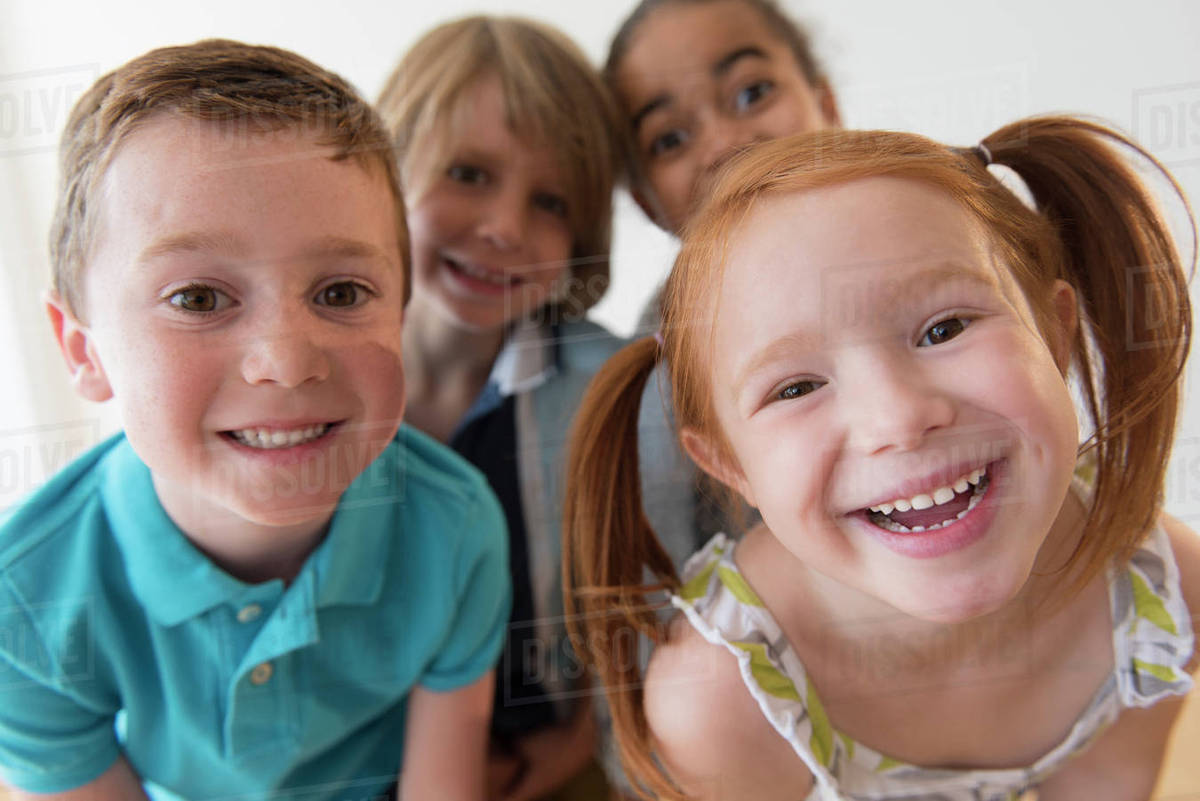 Close up of smiling children - Stock Photo - Dissolve