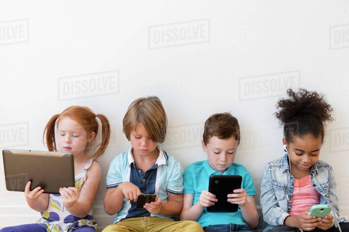 Children using technology - Stock Photo - Dissolve
