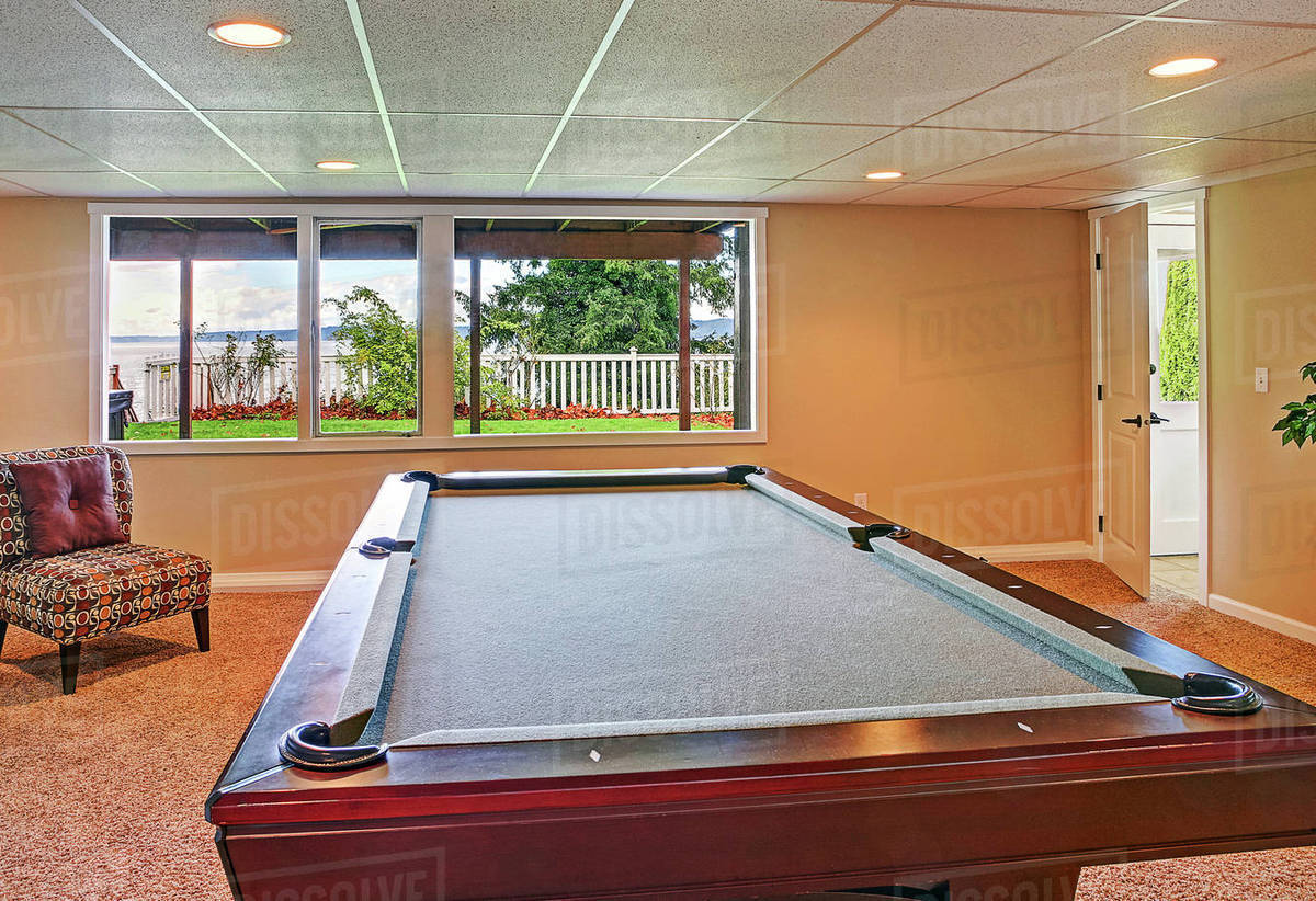 Pool table in game room - Royalty-free Stock Photo | Dissolve