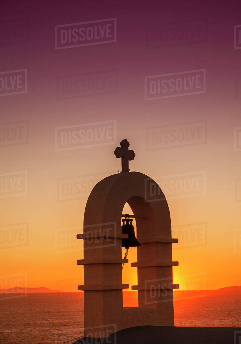 Bell arch with cross and sunset sky - Royalty-free Stock Photo | Dissolve