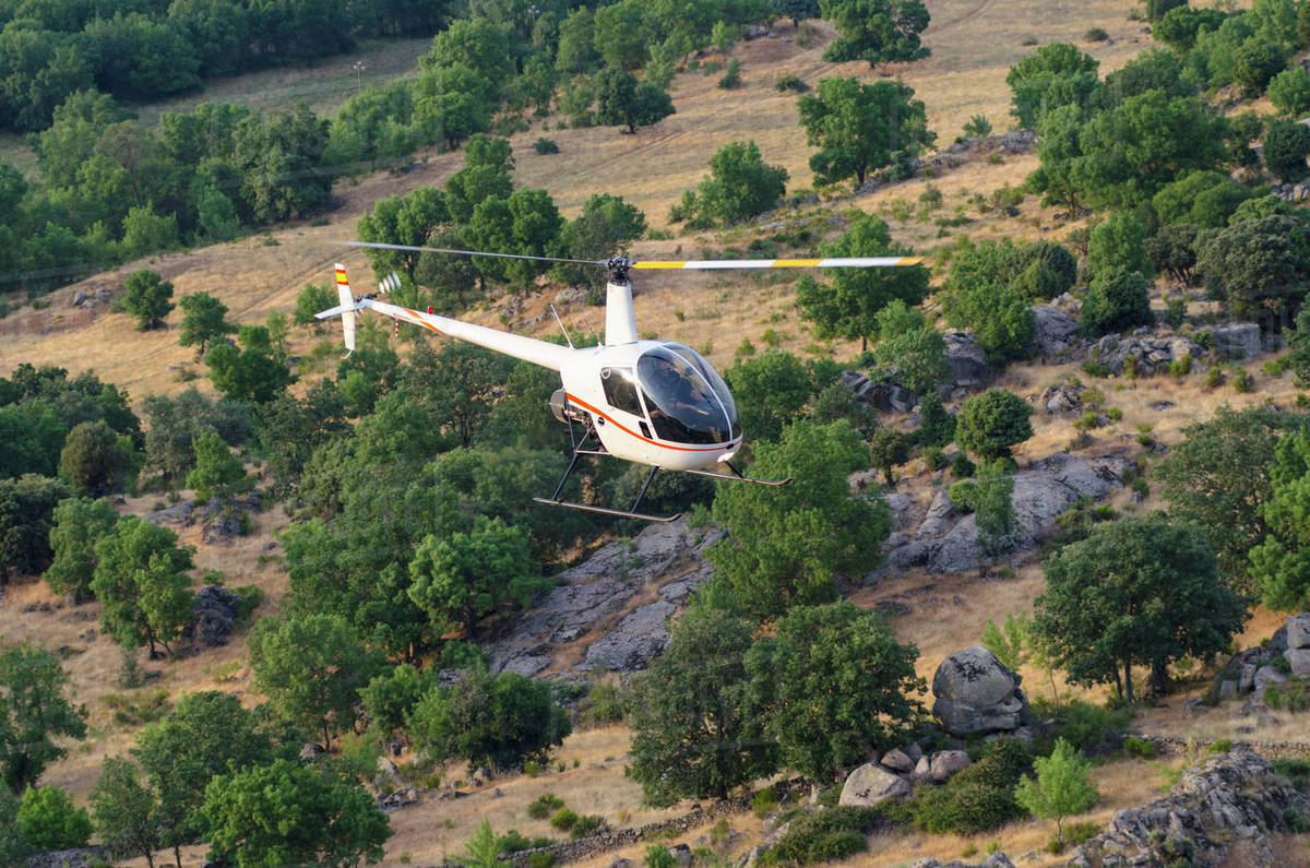 Aerial view of helicopter flying over remote landscape - Royalty-free ...