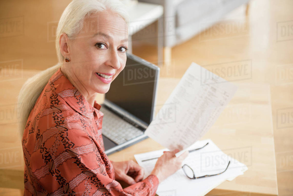 Caucasian woman paying bills on laptop - Royalty-free Stock Photo ...