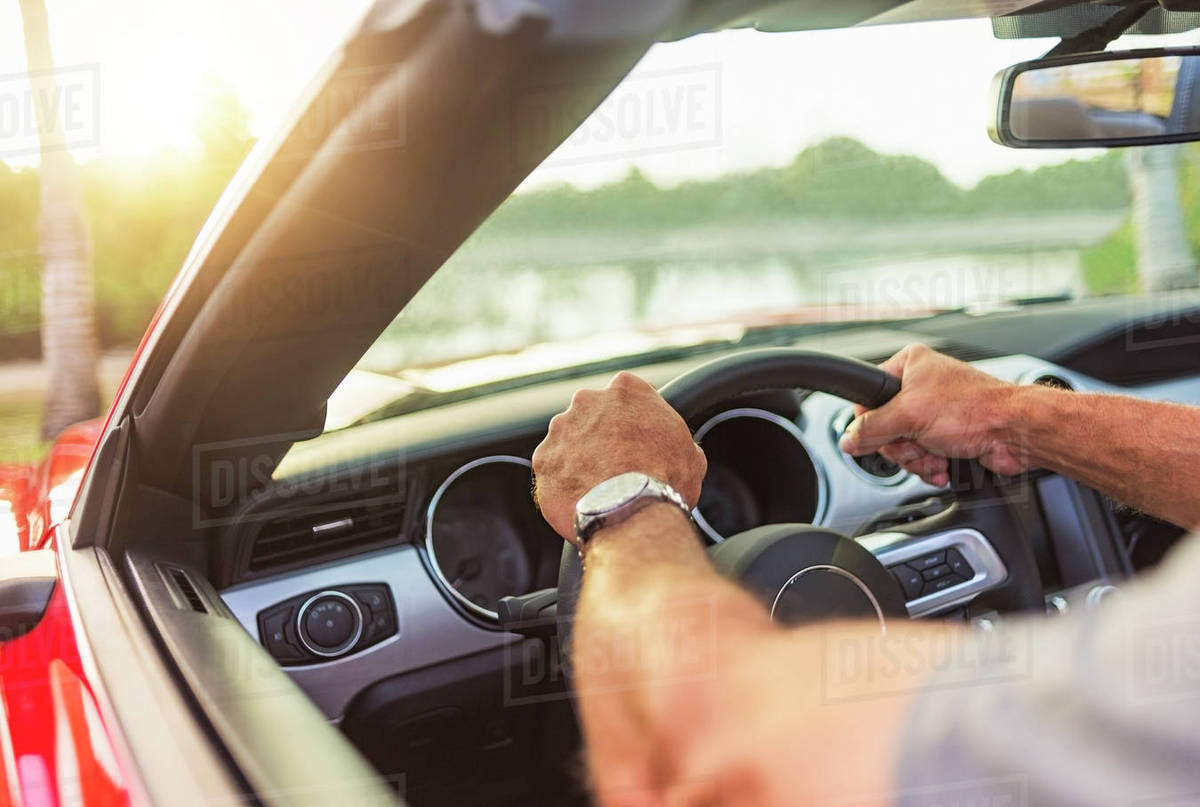 Caucasian man driving convertible - Royalty-free Stock Photo | Dissolve
