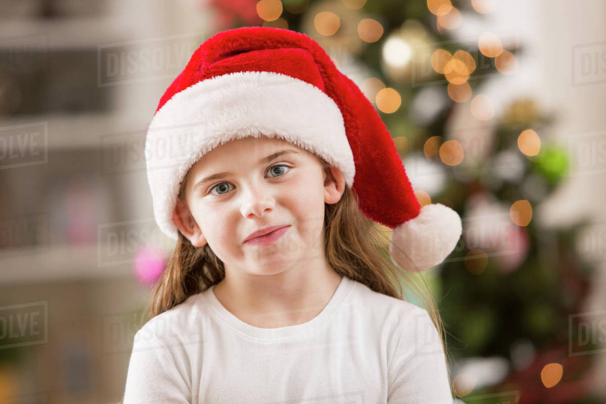 Caucasian girl wearing Santa hat - Royalty-free Stock Photo | Dissolve