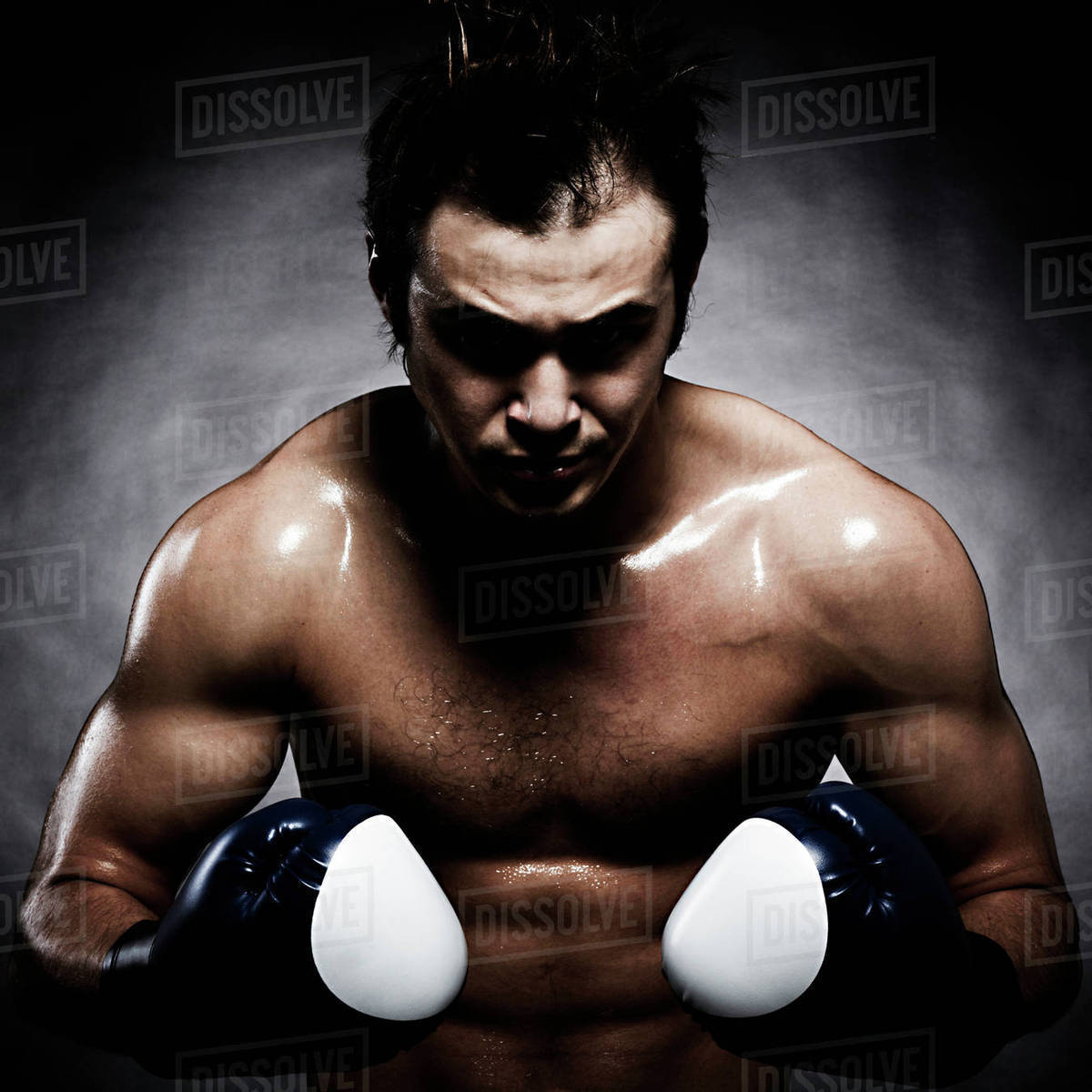 Caucasian boxer flexing his muscles - Stock Photo - Dissolve