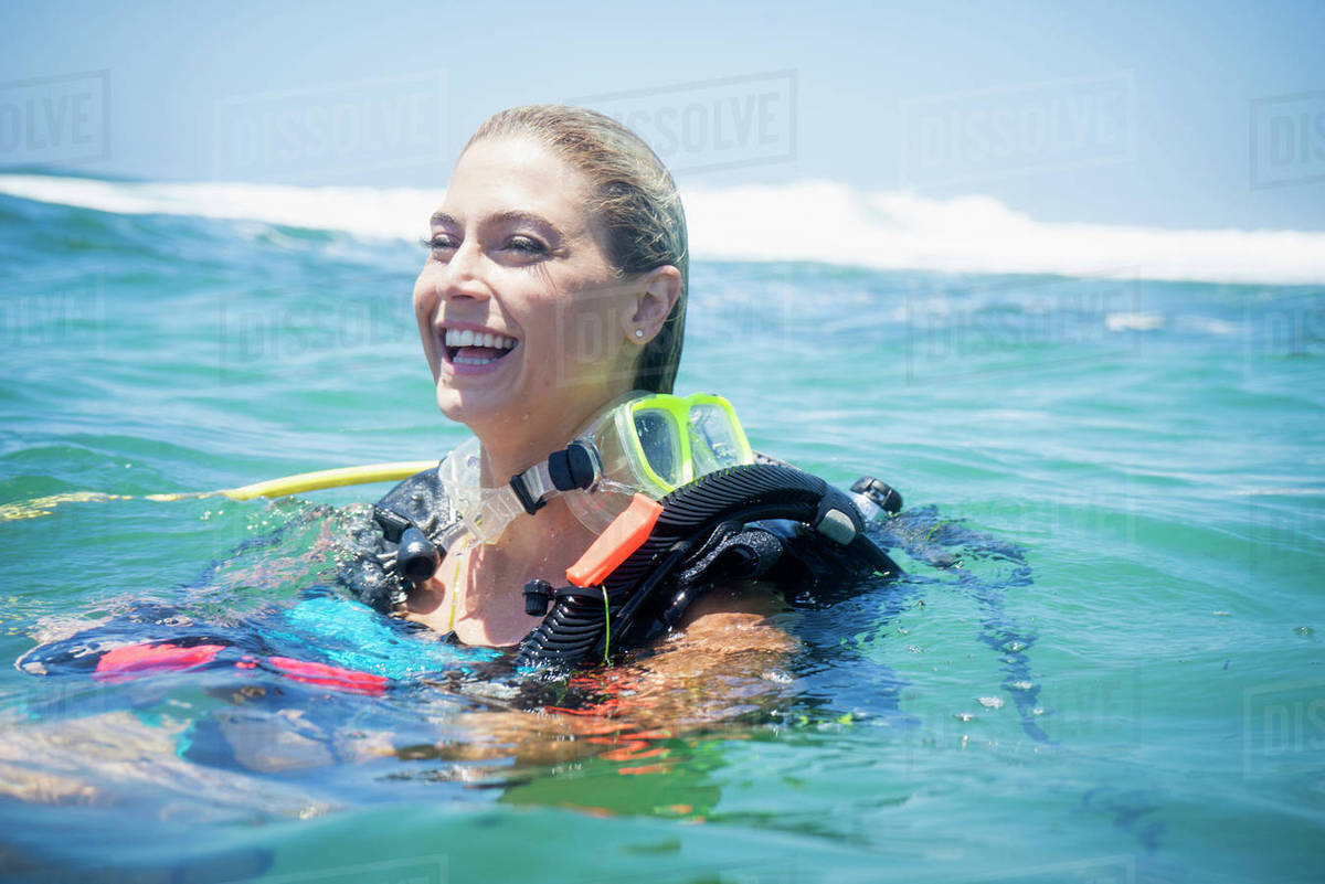 Caucasian diver swimming in ocean - Stock Photo - Dissolve
