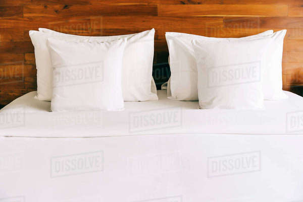Empty bed in modern hotel room - Royalty-free Stock Photo | Dissolve
