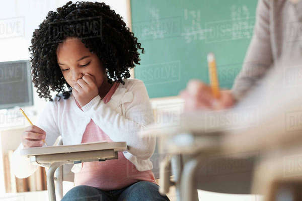 African American student writing in classroom - Royalty-free Stock ...