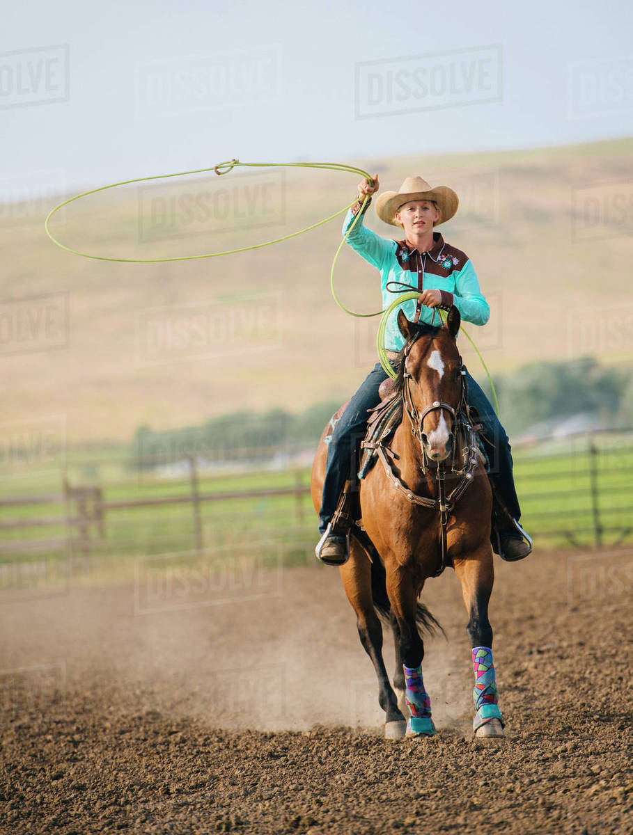 Caucasian cowgirl throwing lasso on horseback - Royalty-free Stock ...