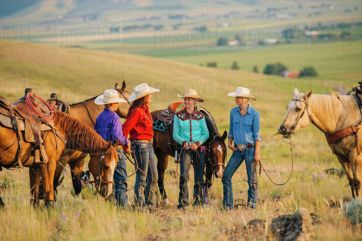 Cowboy and cowgirls with horses on ranch - Royalty-free Stock Photo ...