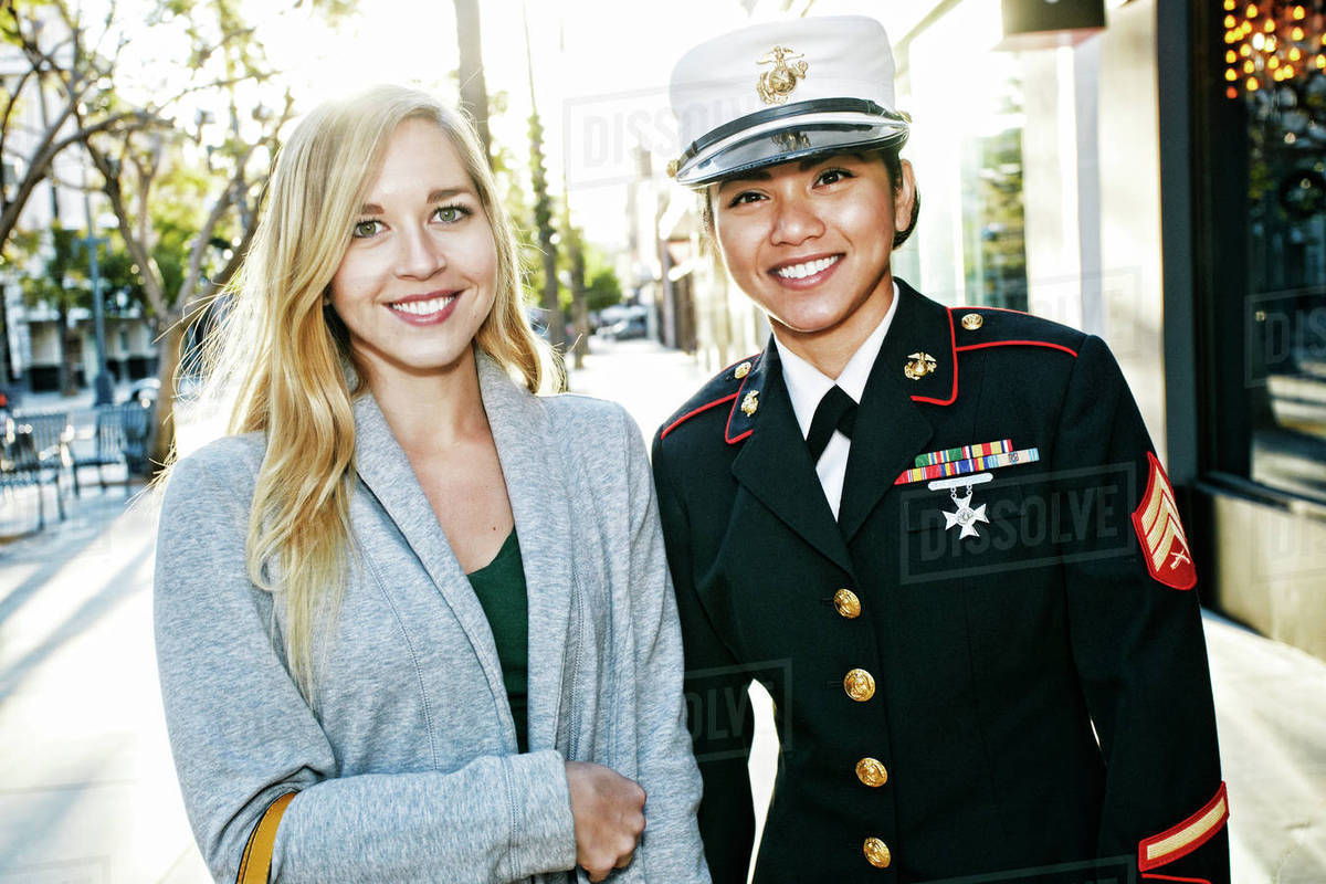 Soldier smiling with friend outdoors - Royalty-free Stock Photo | Dissolve
