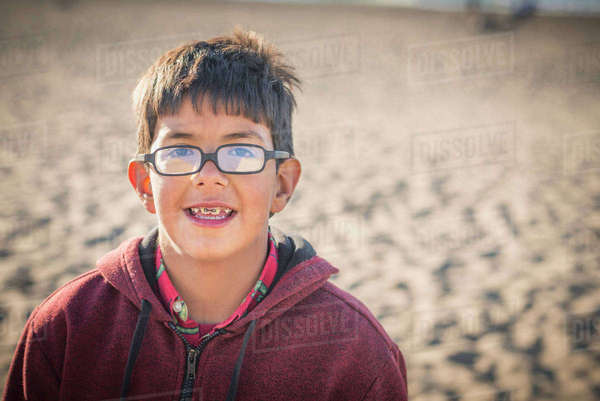 Hispanic boy smiling on beach - Royalty-free Stock Photo | Dissolve