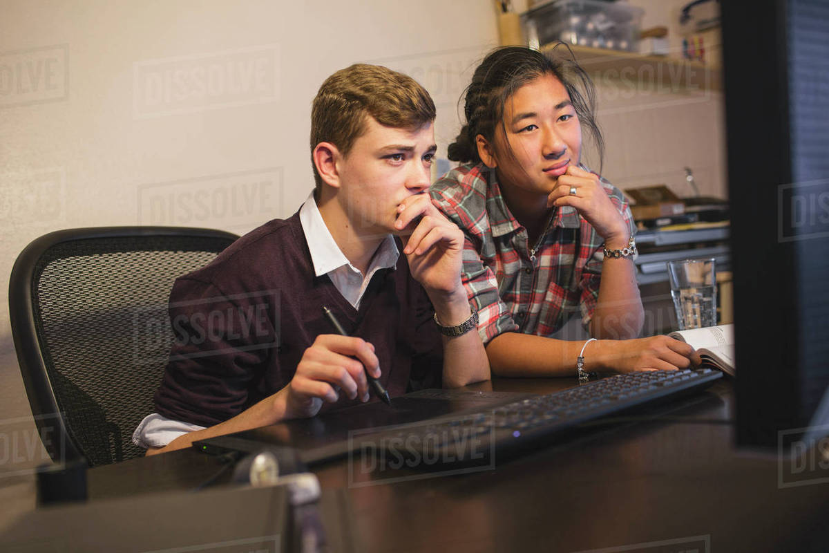 Teenage boys using computer - Royalty-free Stock Photo | Dissolve