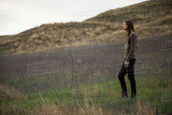 Man walking in rural field - Royalty-free Stock Photo | Dissolve