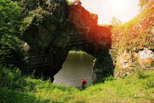 Caucasian man under rock formation arch - Royalty-free Stock Photo ...