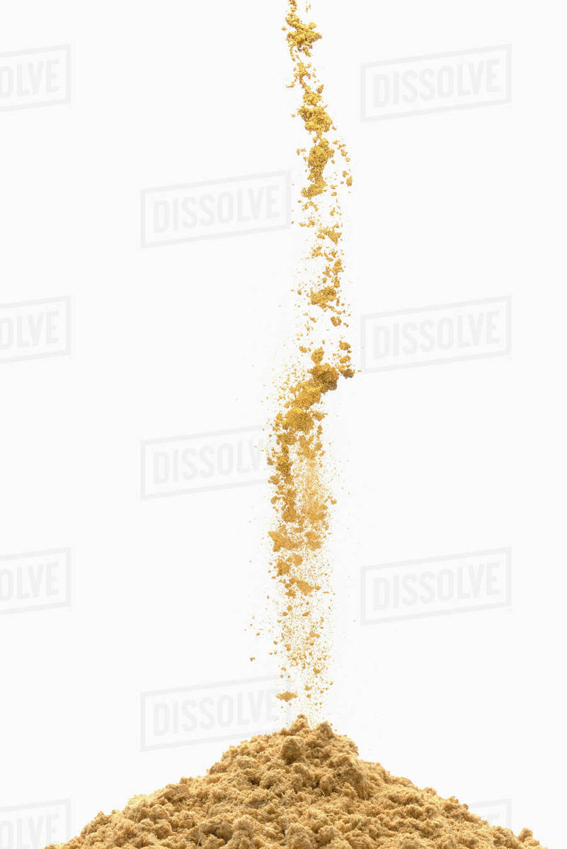 Brown powder pouring into pile - Royalty-free Stock Photo | Dissolve
