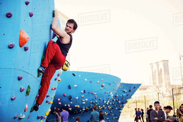 Caucasian man climbing outdoor climbing wall - Royalty-free Stock Photo ...