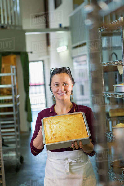 Caucasian woman showing cake in bakery pan - Royalty-free Stock Photo ...