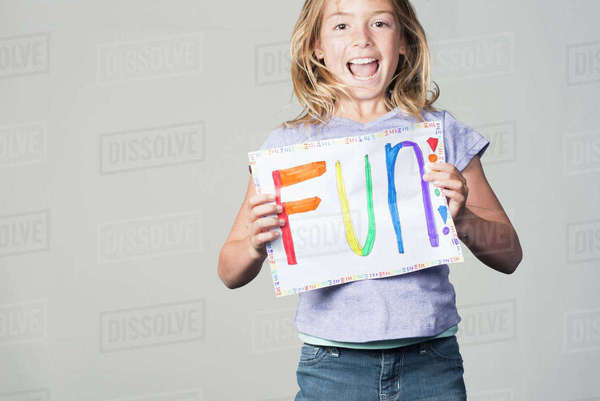 Happy Mixed Race girl holding fun sign - Stock Photo - Dissolve