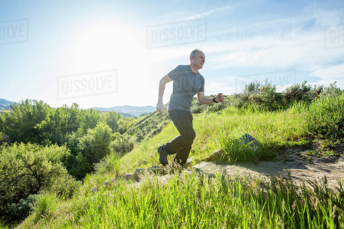 Caucasian man running up staircase on hill - Royalty-free Stock Photo ...