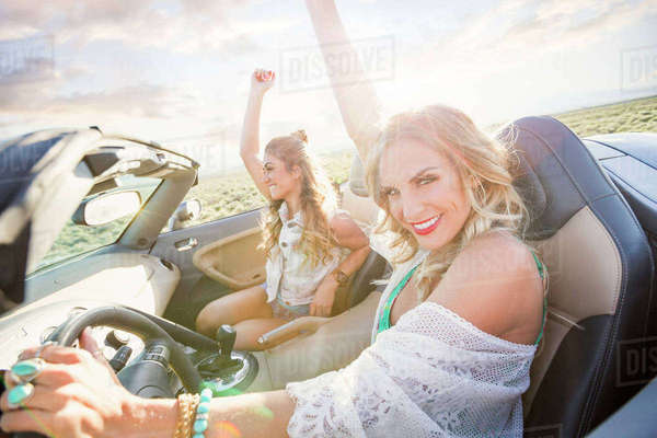 Caucasian women driving in sports car - Royalty-free Stock Photo | Dissolve