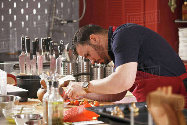 Chef cooking in commercial kitchen - Royalty-free Stock Photo | Dissolve