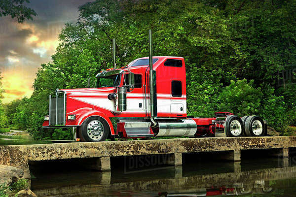 Semi-truck driving on bridge over river - Royalty-free Stock Photo ...