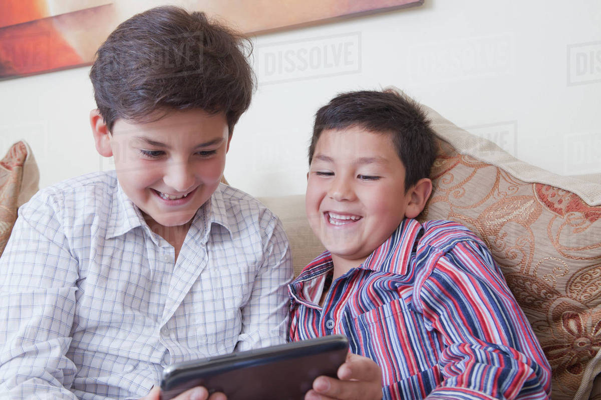 Hispanic brothers using digital tablet - Royalty-free Stock Photo ...
