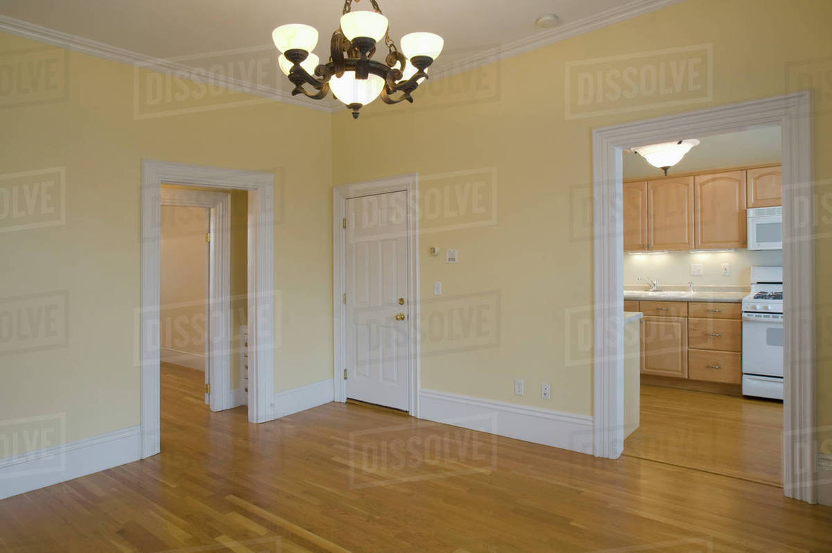 Empty room in apartment with hardwood floor - Stock Photo - Dissolve