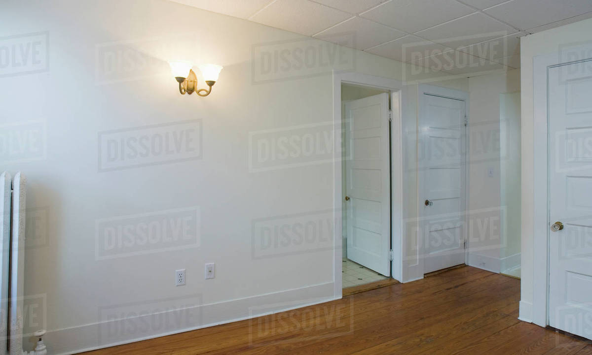 Empty room in apartment with hardwood floor - Stock Photo - Dissolve