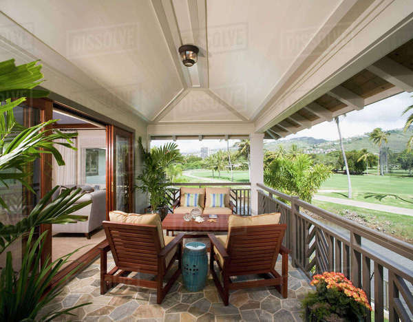 Back patio with wood furniture and view of golf course - Royalty-free ...
