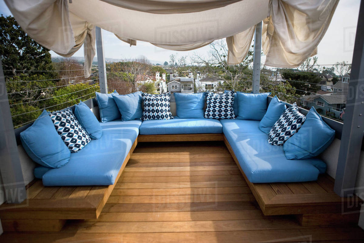 Rooftop sitting area with blue cushions - Royalty-free Stock Photo ...