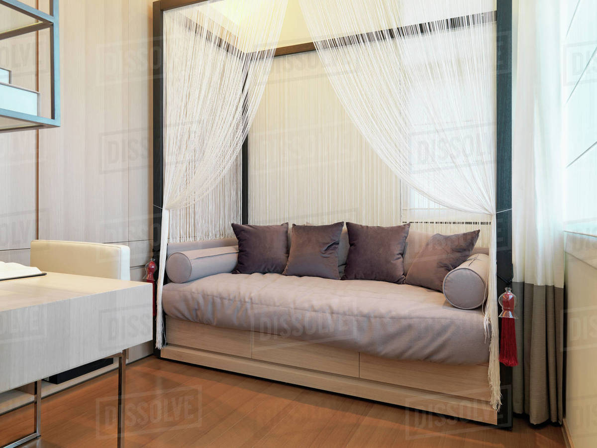 Contemporary daybed with mosquito net - Royalty-free Stock Photo | Dissolve