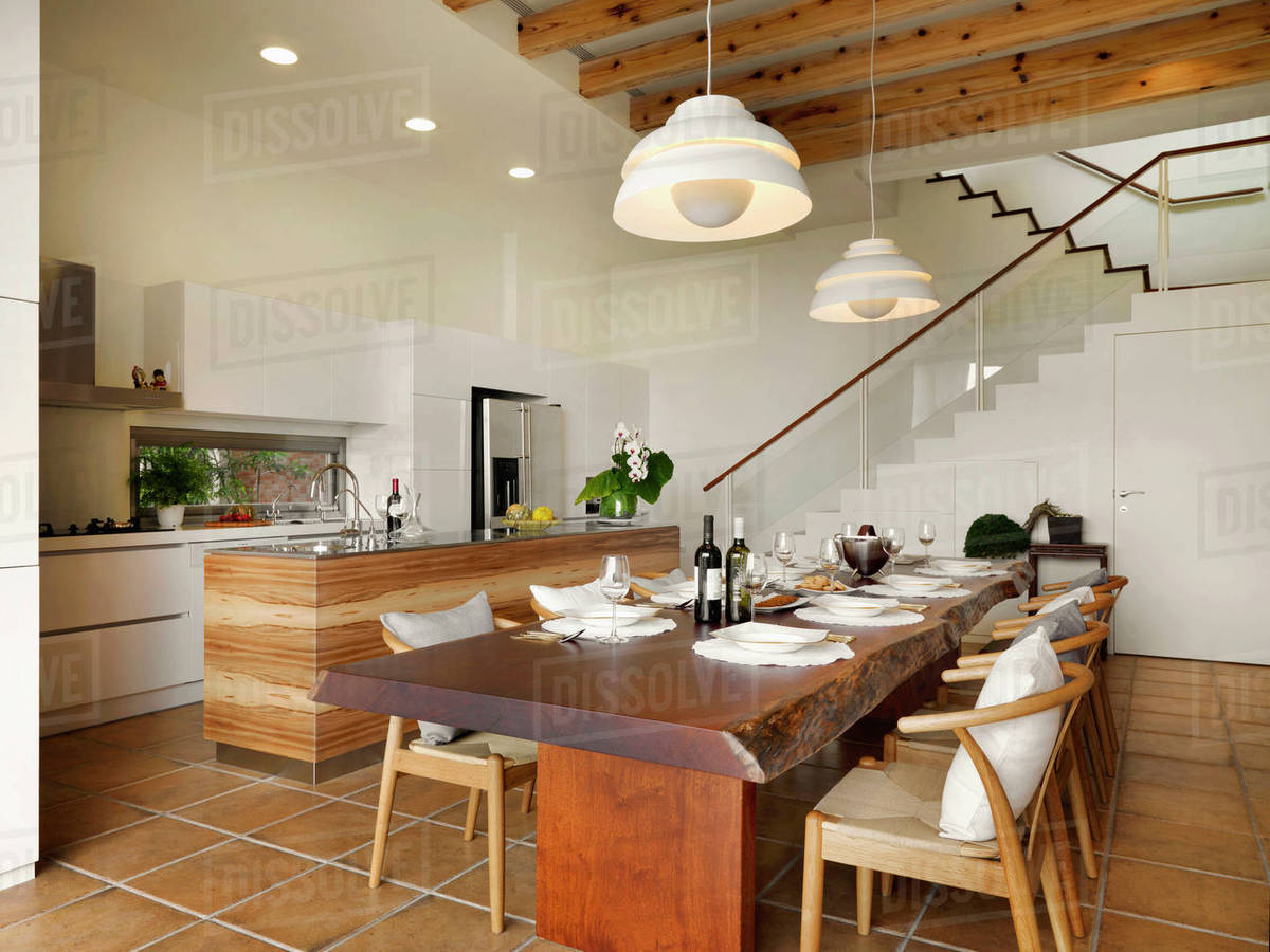 Large wooden dining table in kitchen - Royalty-free Stock Photo | Dissolve