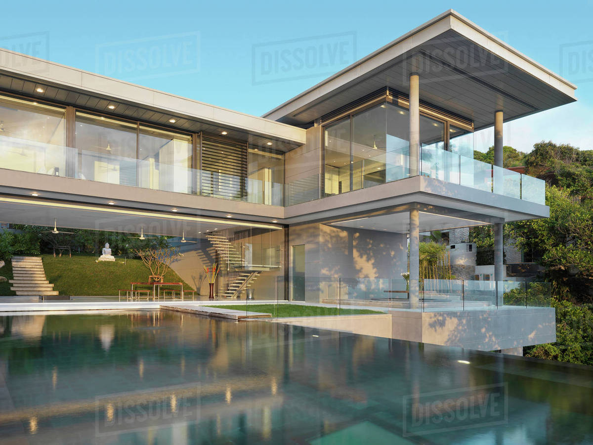 Pool out front of large modern home - Stock Photo - Dissolve