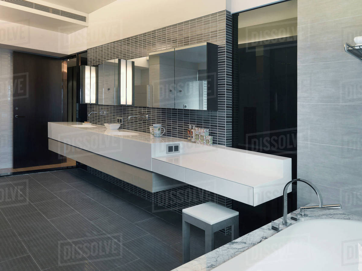 Modern bathroom with long countertop - Stock Photo - Dissolve