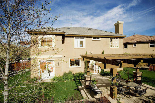 Rear Exterior of Home with Large Terrace Patio - Stock Photo - Dissolve