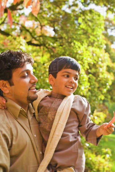 Indian father holding son - Royalty-free Stock Photo | Dissolve